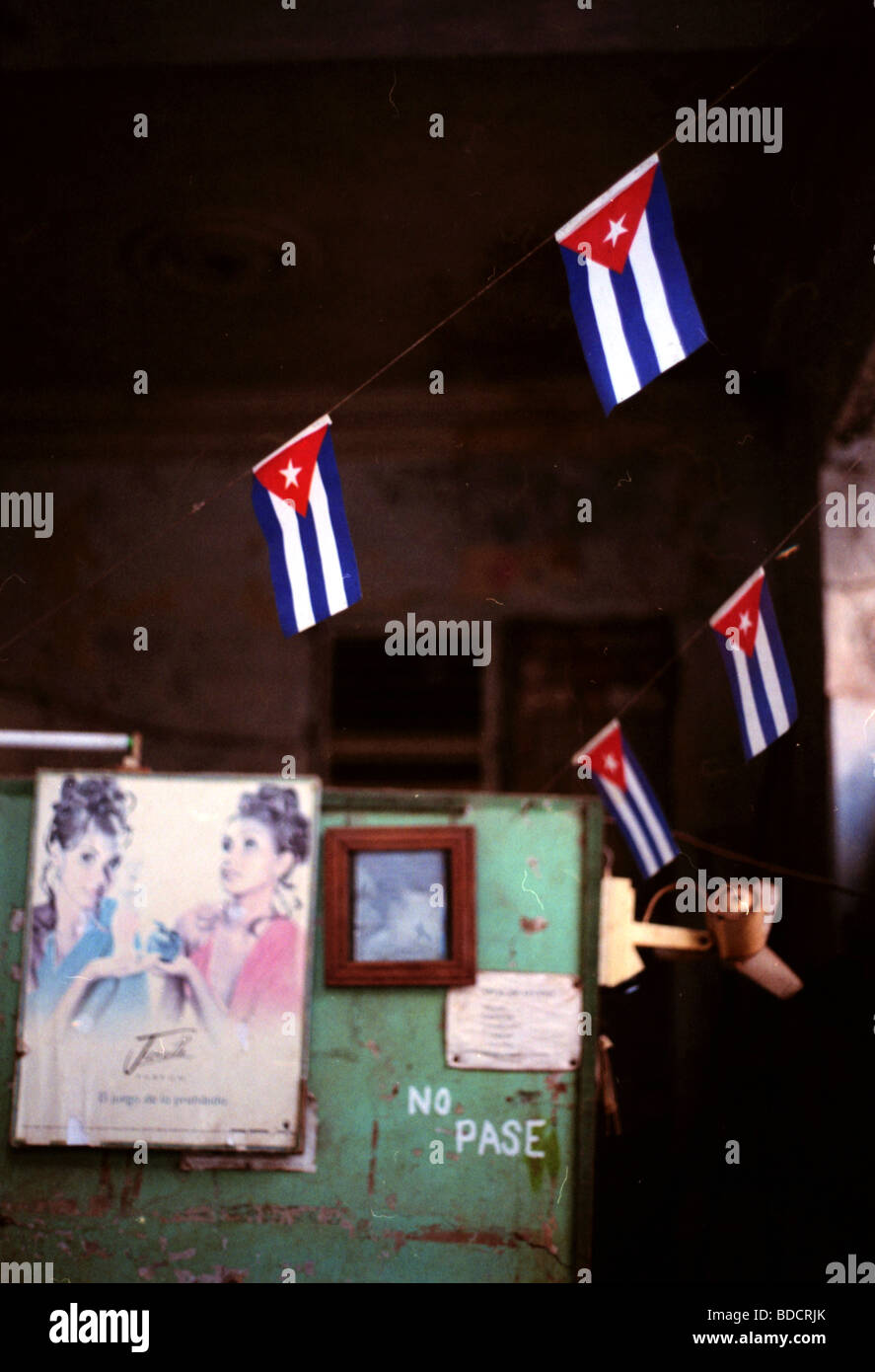 Cuban flags hanging in a government owned grocery store Stock Photo - Alamy