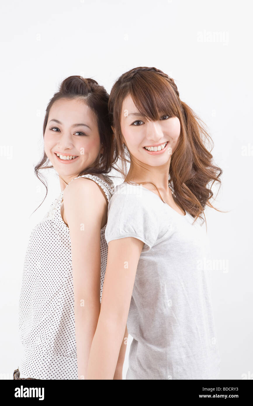 Two young women standing Stock Photo - Alamy
