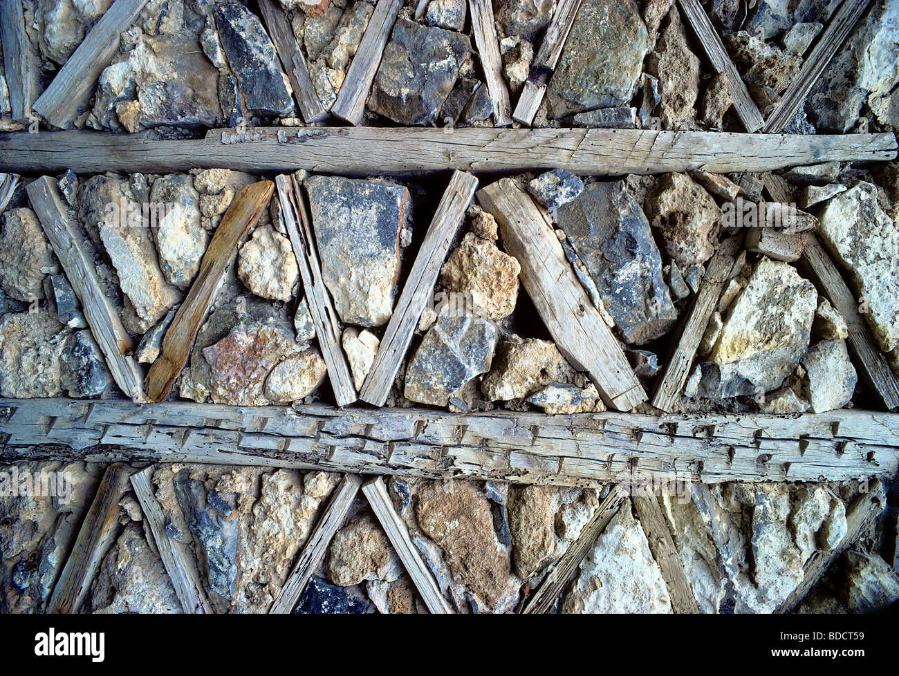 Traditional masonry with wood and broken stones, unplastered, framework ...