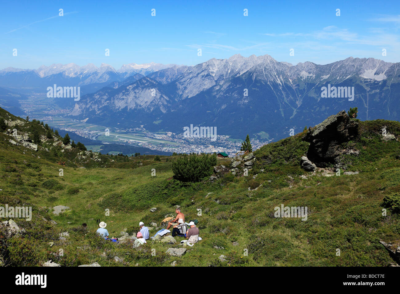 Hikers resting at Mt. Patscherkofel, overlooking the Inntal valley ...