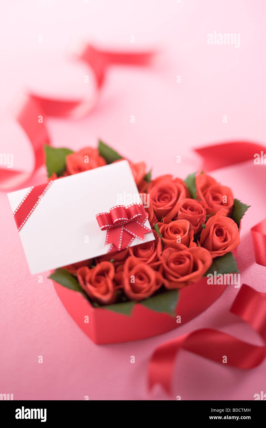 Red rose in heart shaped box and message card Stock Photo - Alamy