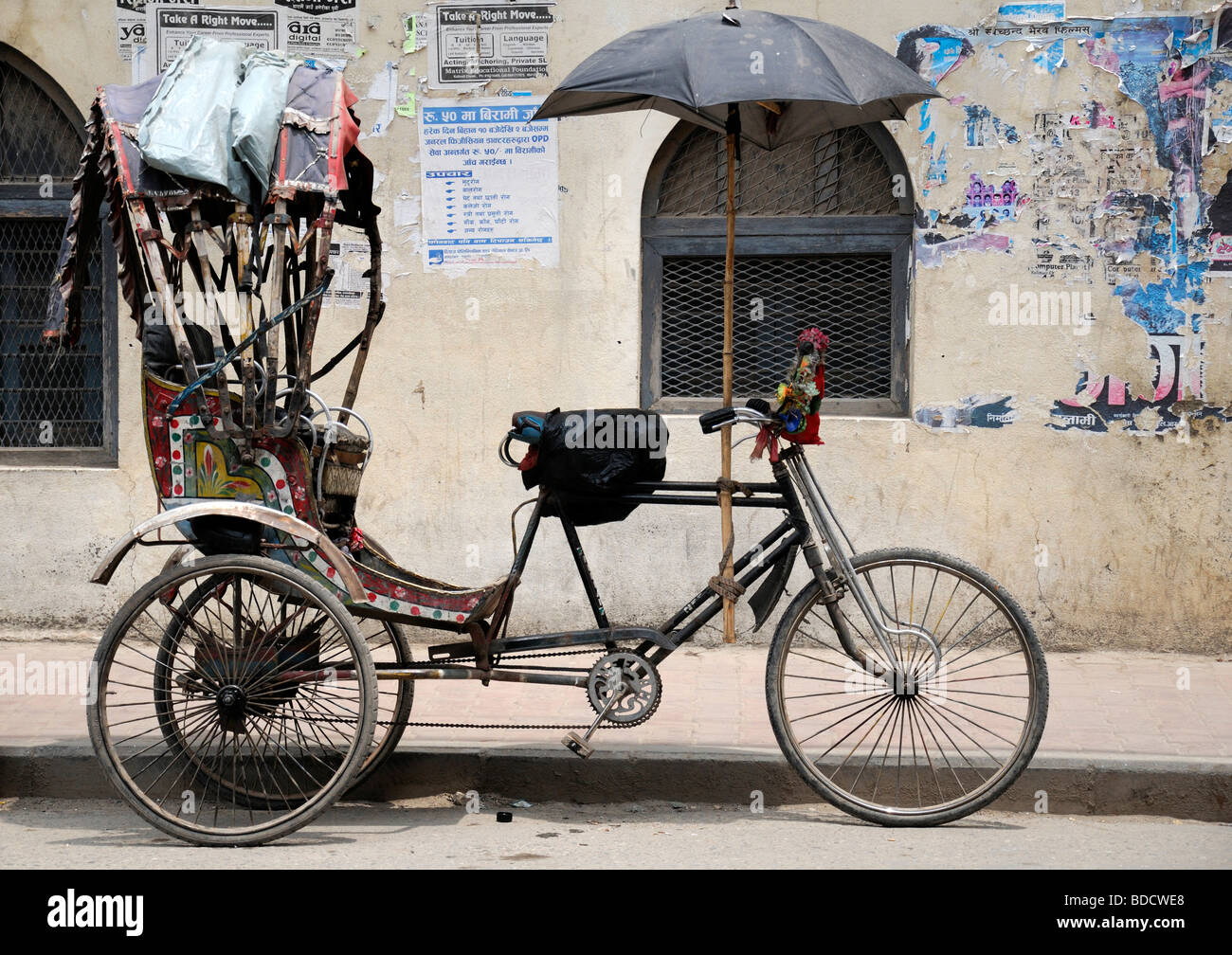 Curious looking rickshaw bicycle transport with umbrella for the driver ...