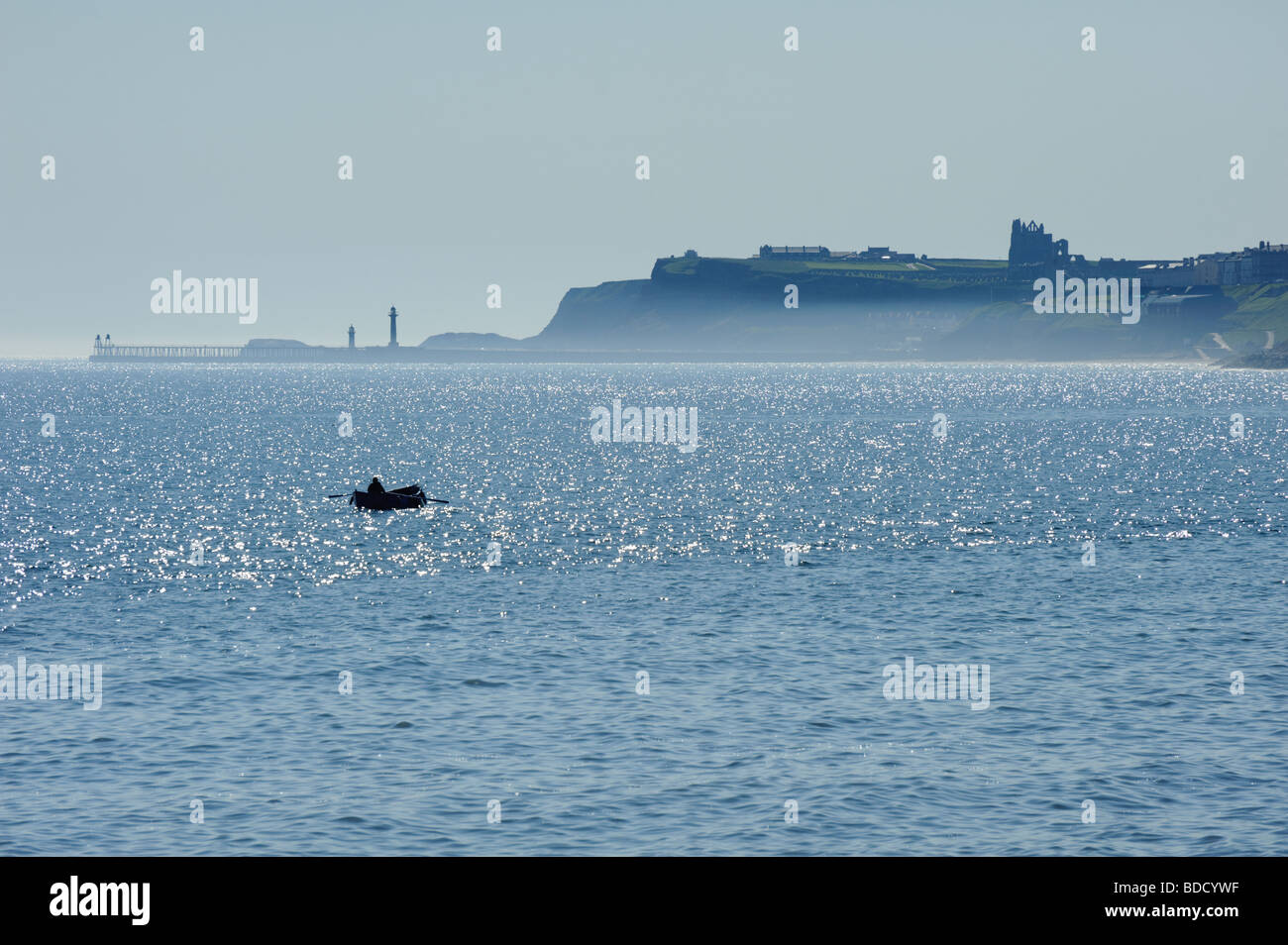 View from Sandsend of Whitby Abbey and harbour, as the last of the sea ...