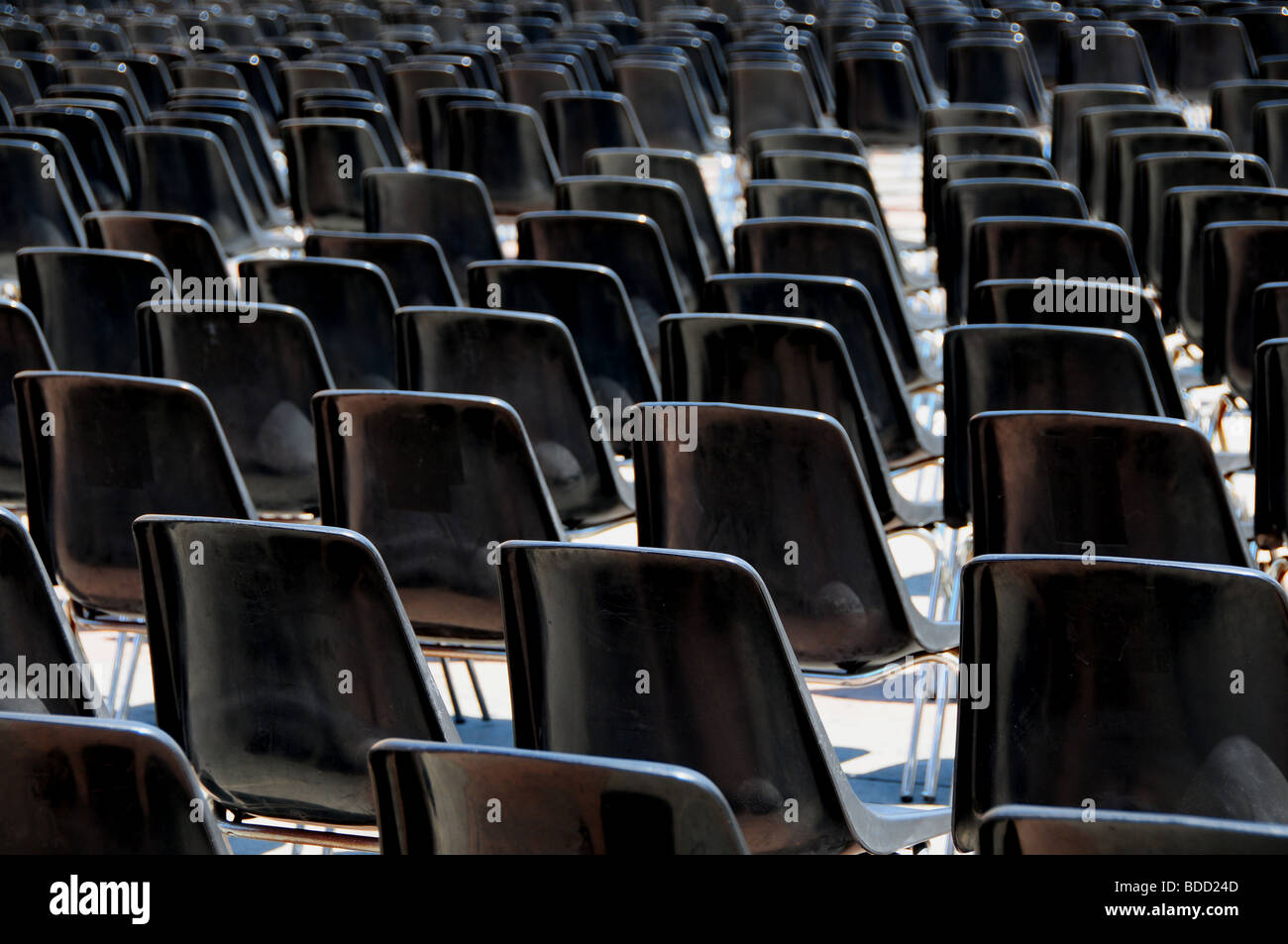 Rows of black seats in an arena Stock Photo - Alamy