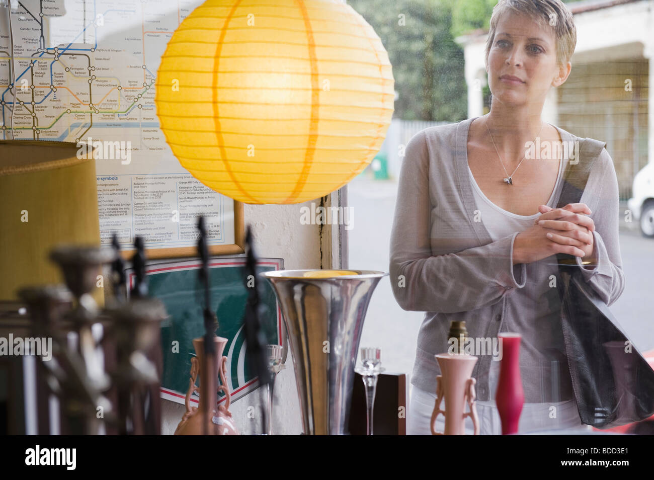 Woman window shopping in a store Stock Photo - Alamy