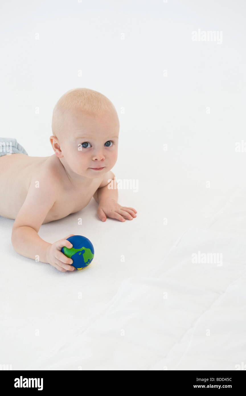 Baby boy holding a ball Stock Photo - Alamy