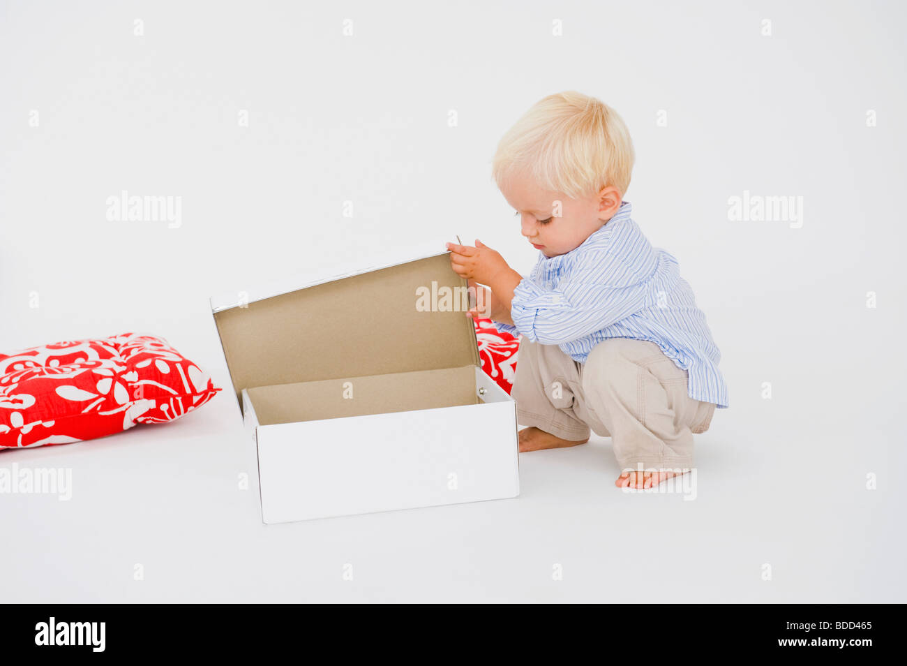 Baby boy opening a box Stock Photo - Alamy