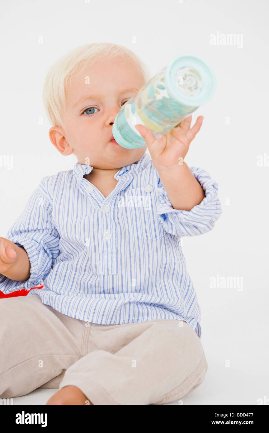 Baby boy drinking water from a baby bottle Stock Photo - Alamy