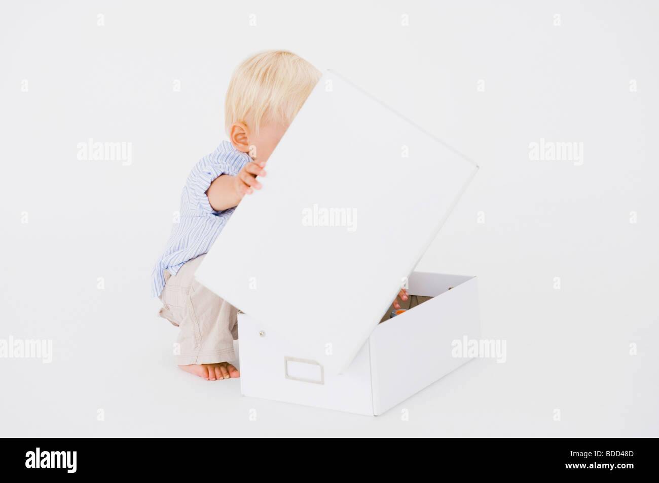 Baby boy opening a box Stock Photo - Alamy