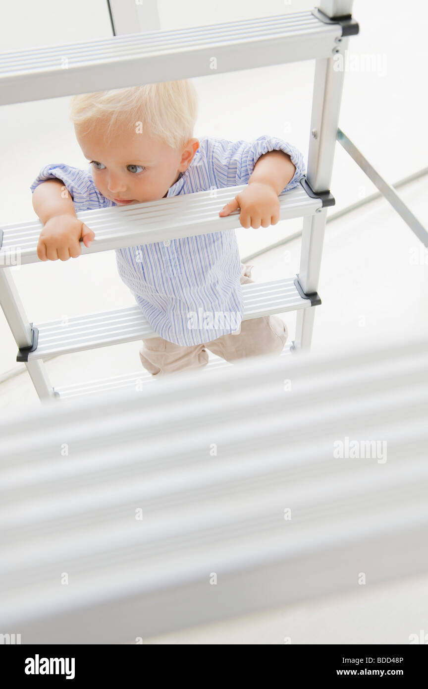 Baby boy climbing a step ladder Stock Photo - Alamy