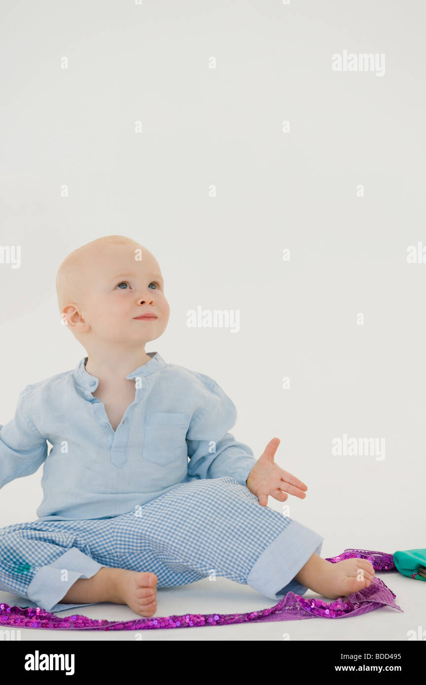 Baby boy playing with a ribbon Stock Photo - Alamy