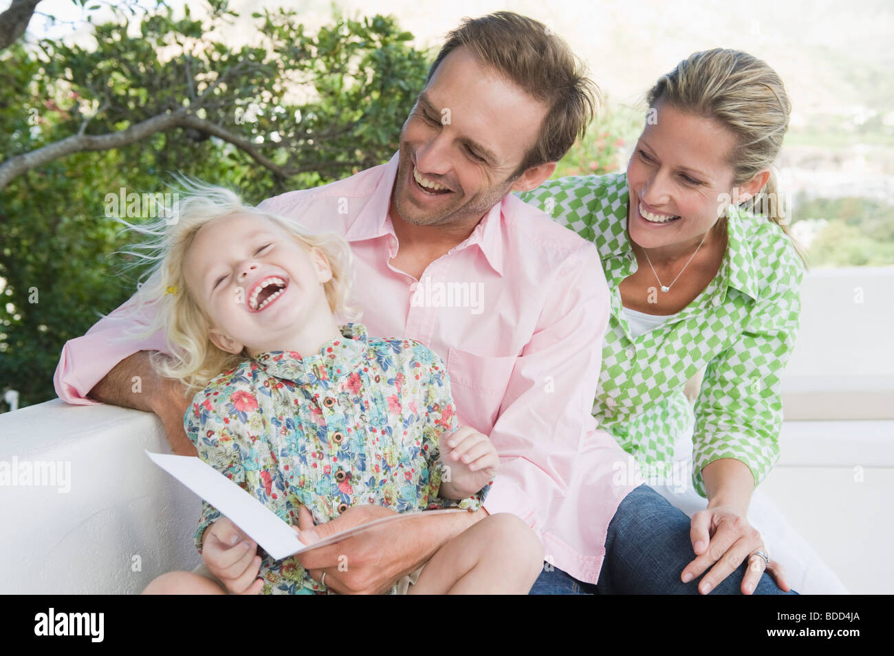 Girl smiling with her parents Stock Photo - Alamy