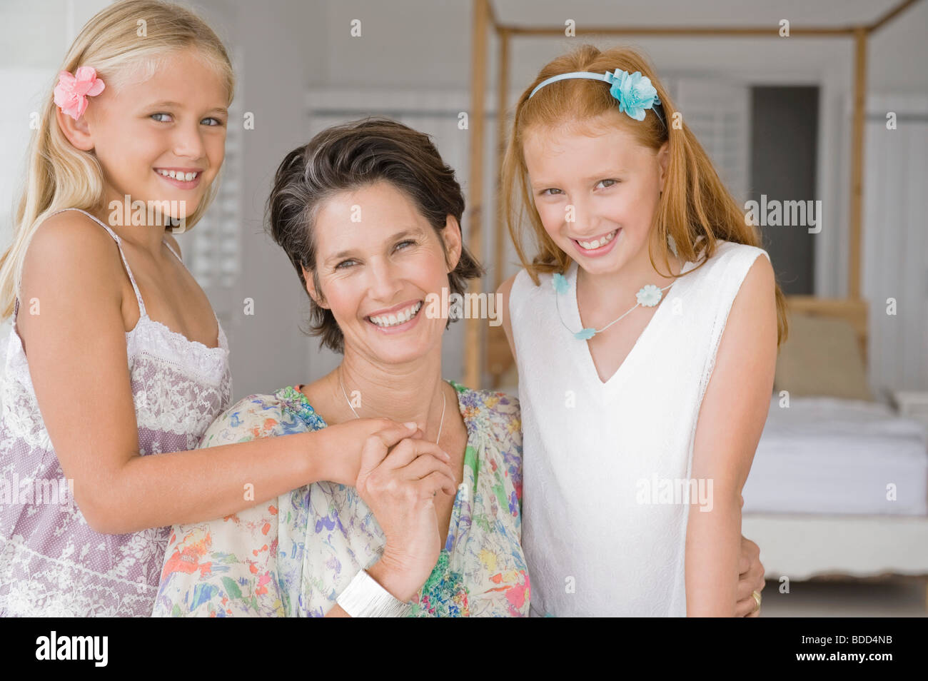 Woman smiling with her two daughters Stock Photo - Alamy