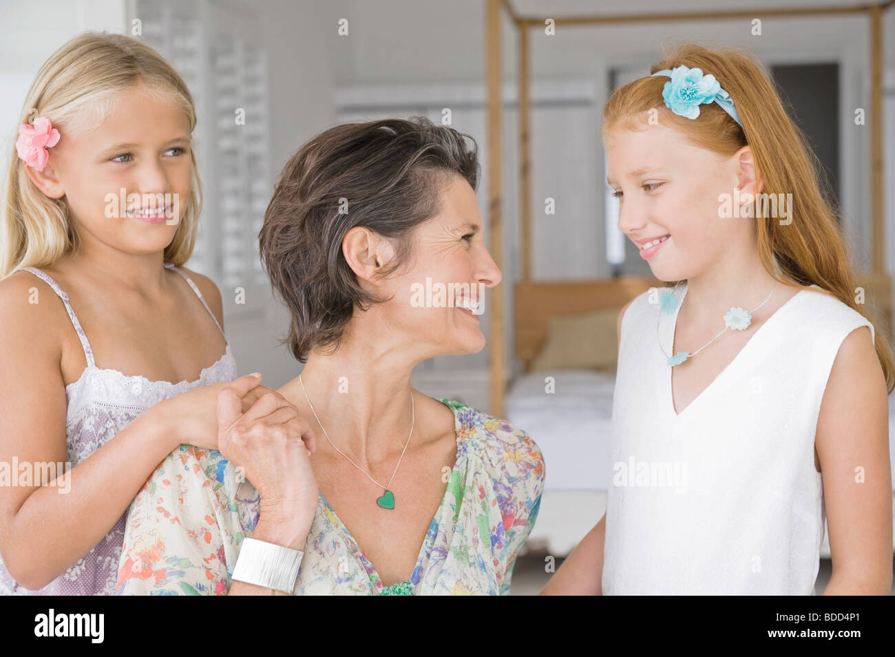 Woman smiling with her two daughters Stock Photo - Alamy