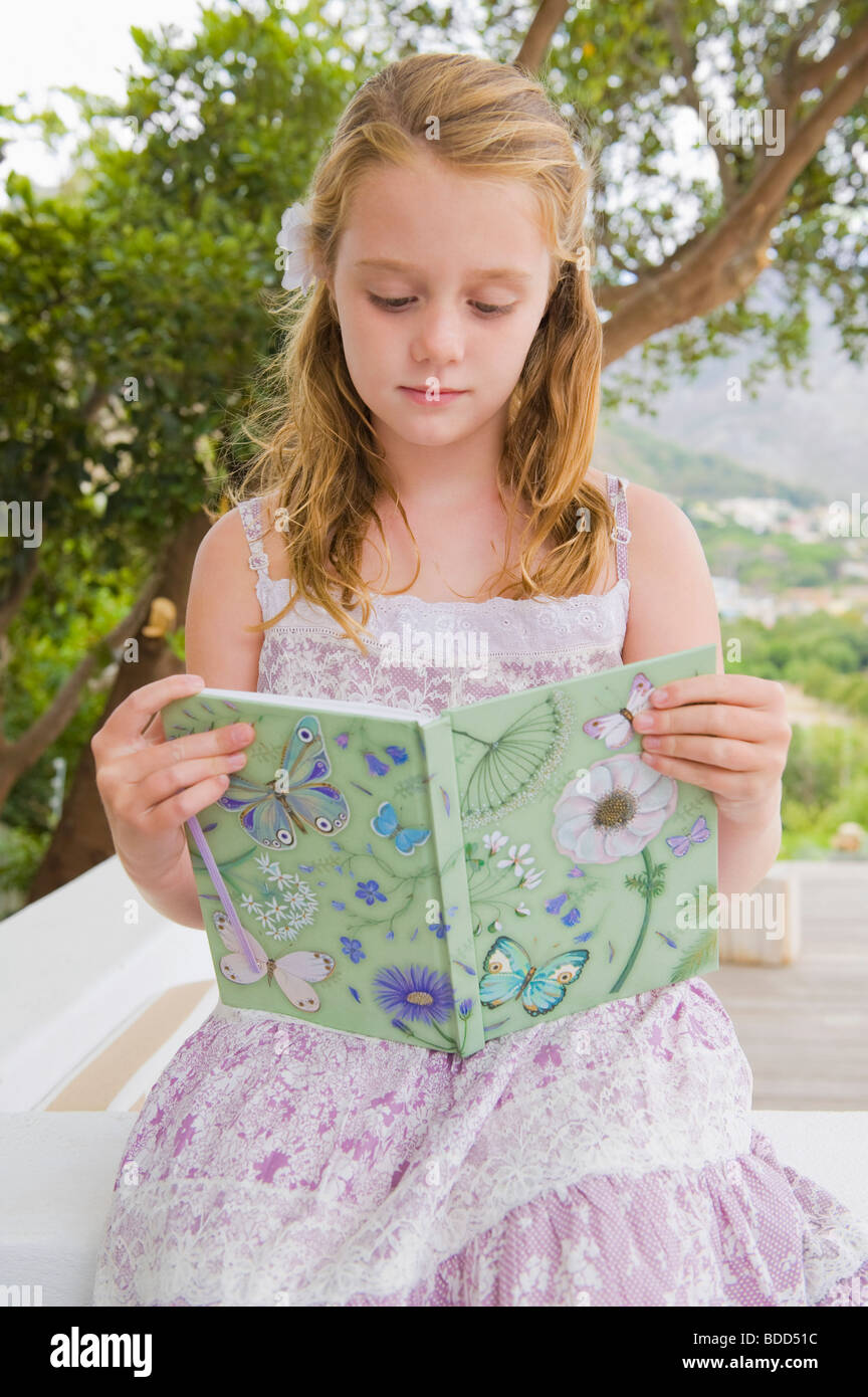 Girl reading a book Stock Photo - Alamy