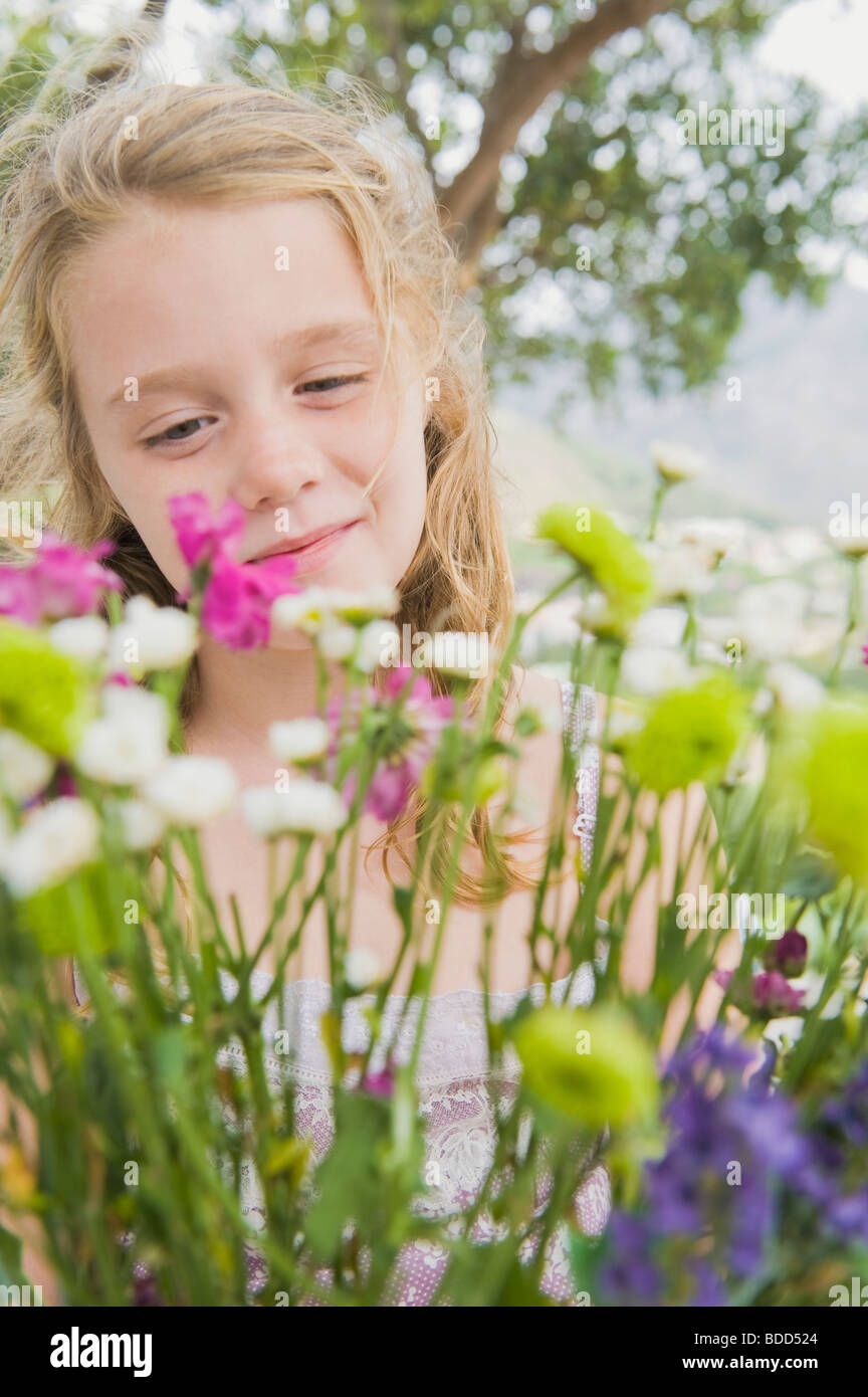 Girl looking at flowers Stock Photo - Alamy