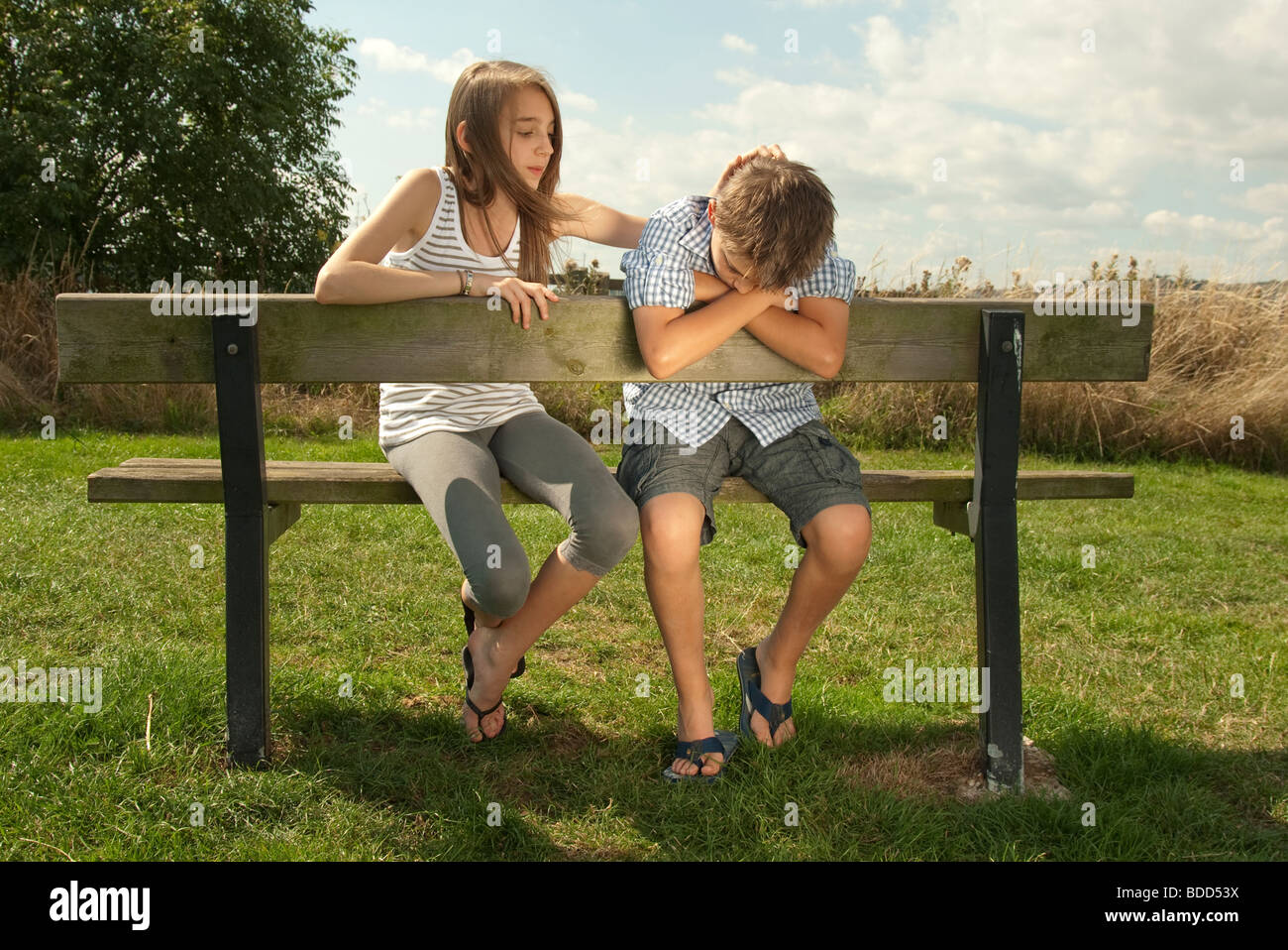 brother & sister sitting on bench Stock Photo - Alamy