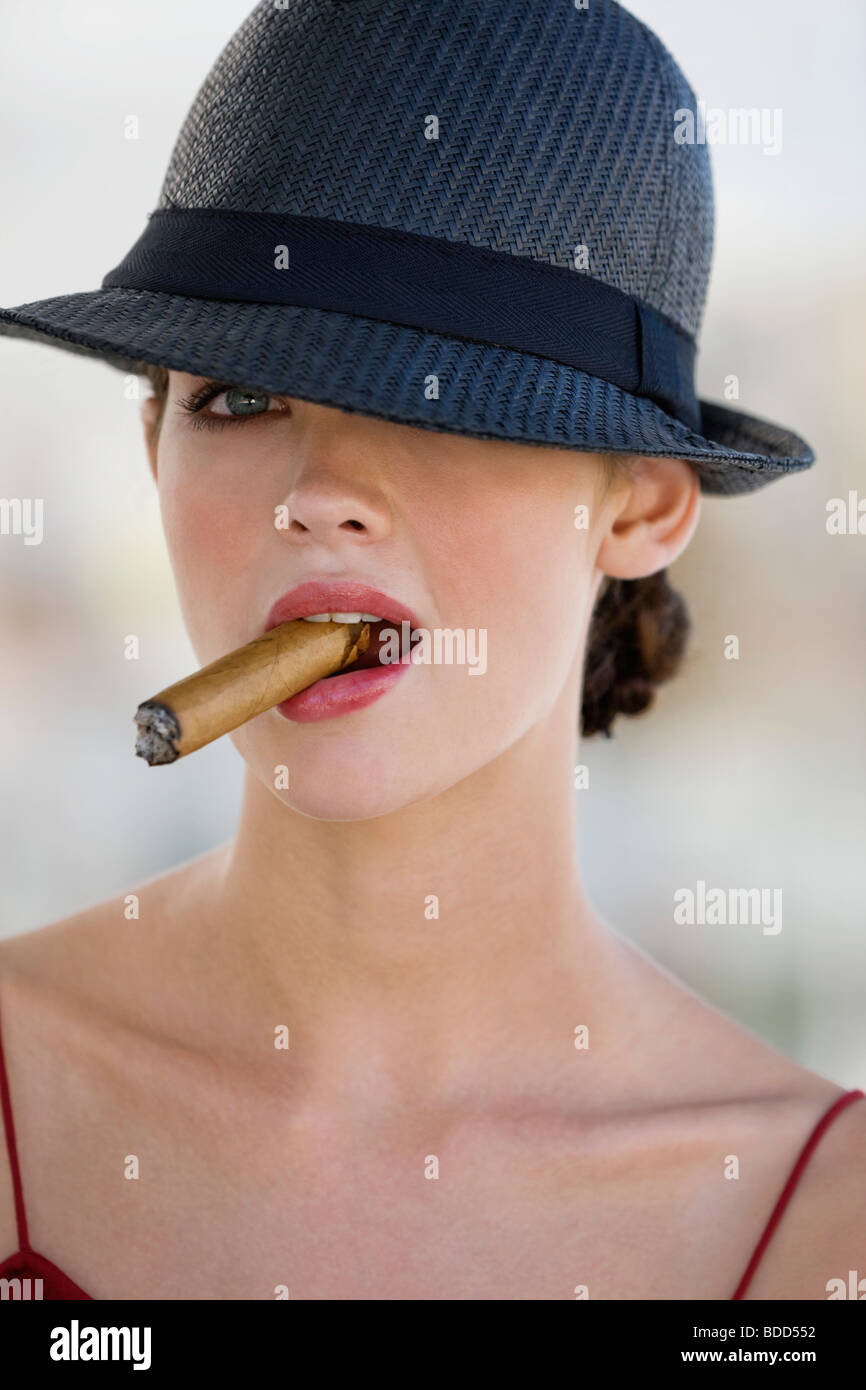 Fashion model smoking a cigar Stock Photo - Alamy