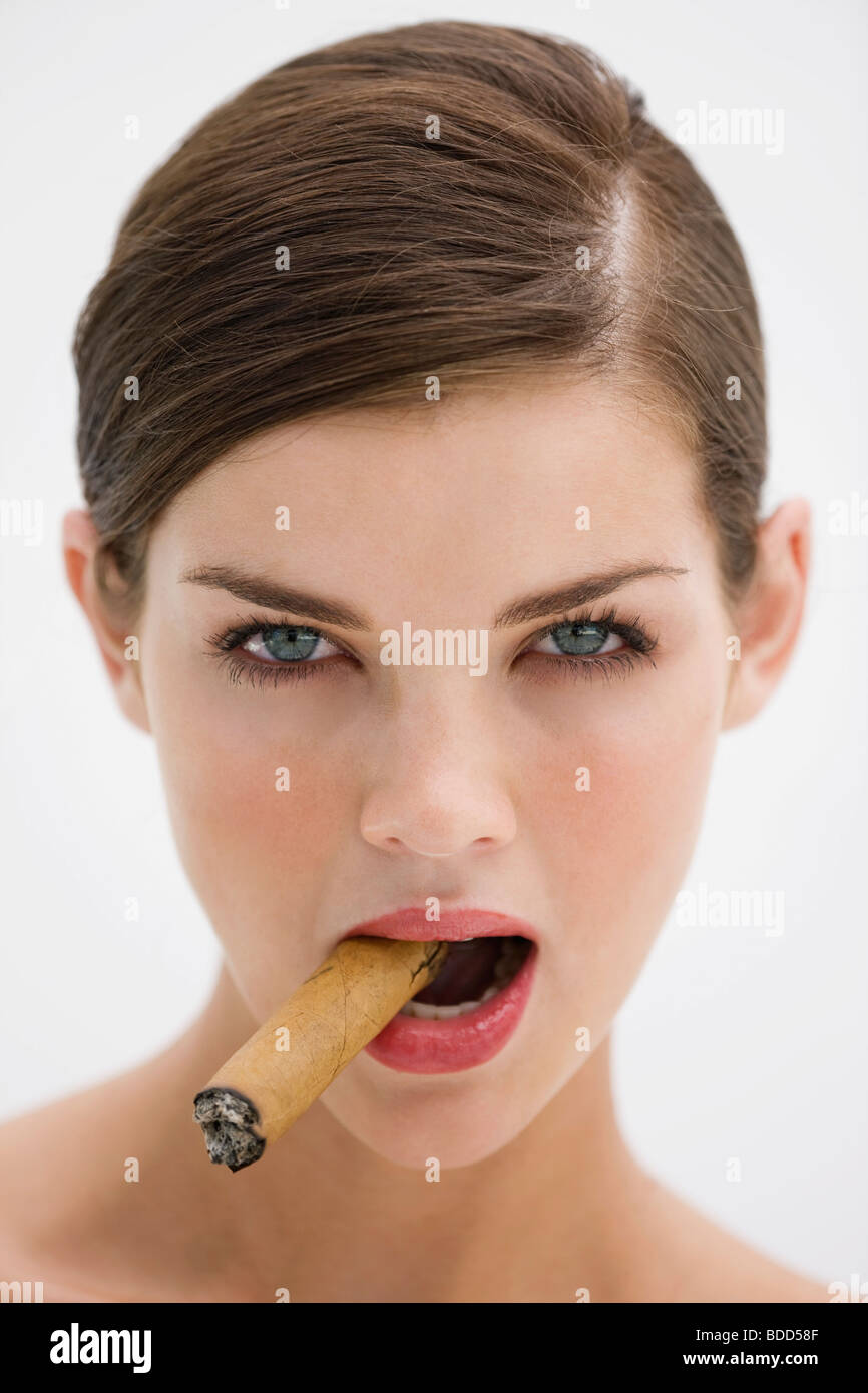 Portrait of a fashion model smoking a cigar Stock Photo - Alamy
