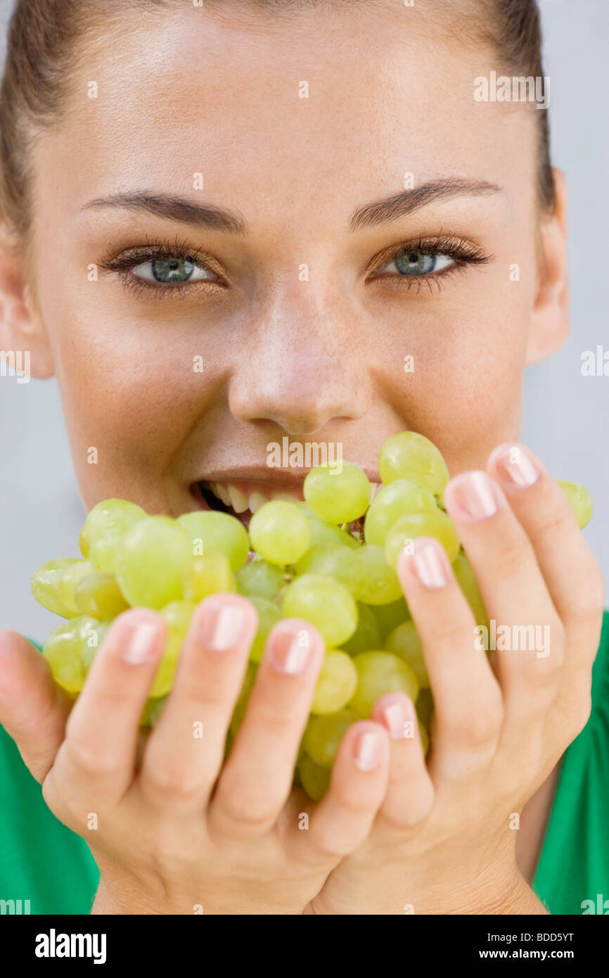 Woman eating grapes Stock Photo - Alamy