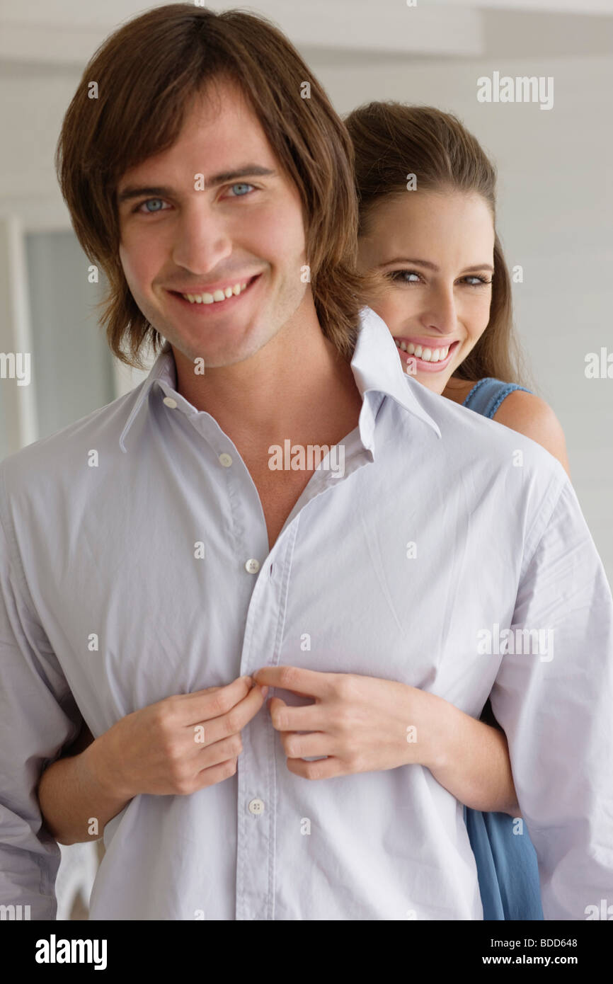 Woman embracing a man from behind Stock Photo - Alamy