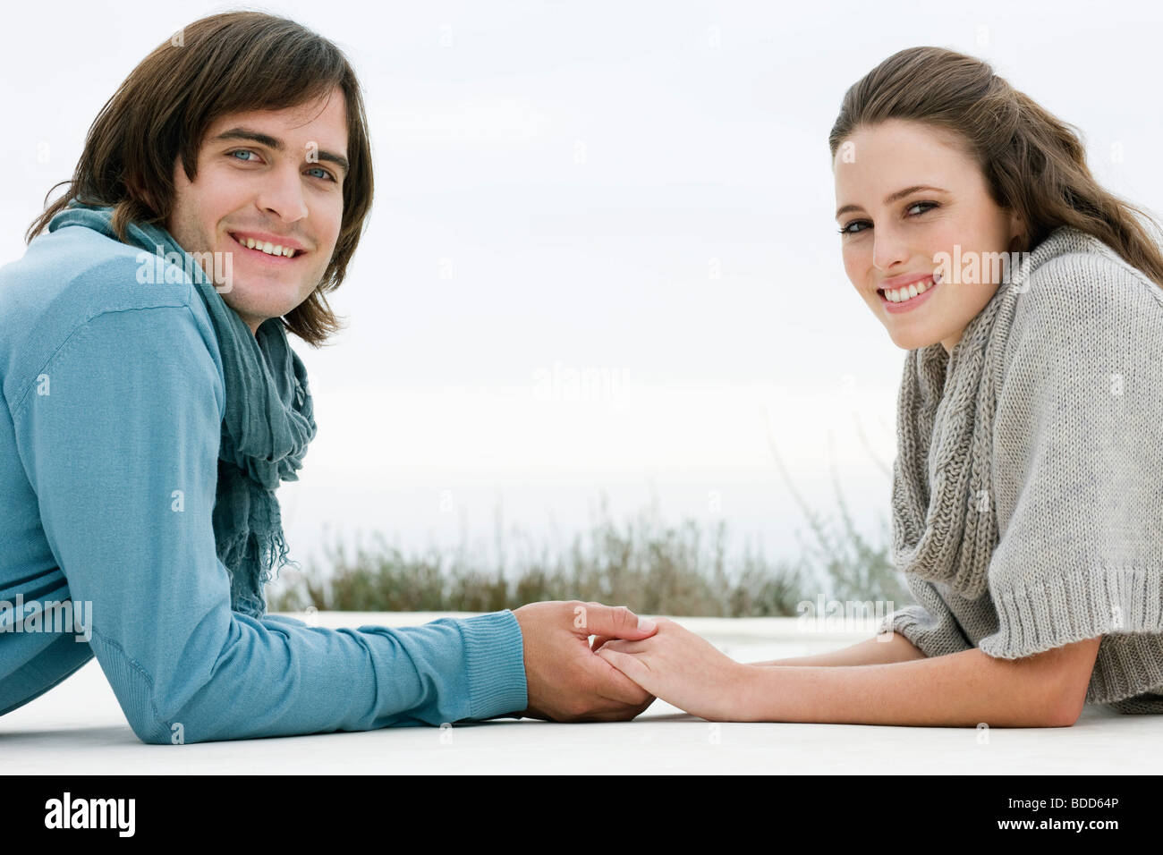 Couple holding hands of each other and smiling Stock Photo - Alamy