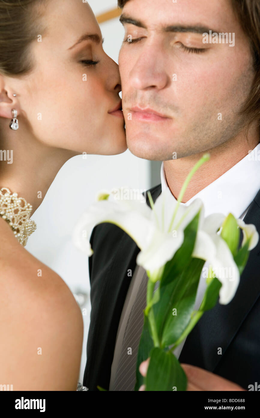 Bride kissing groom Stock Photo - Alamy