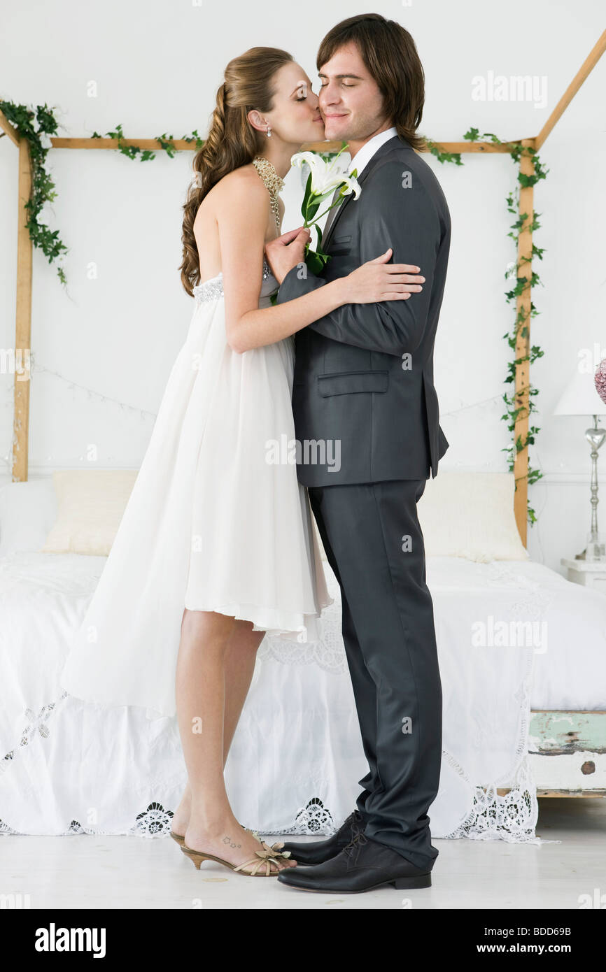 Bride kissing groom Stock Photo - Alamy