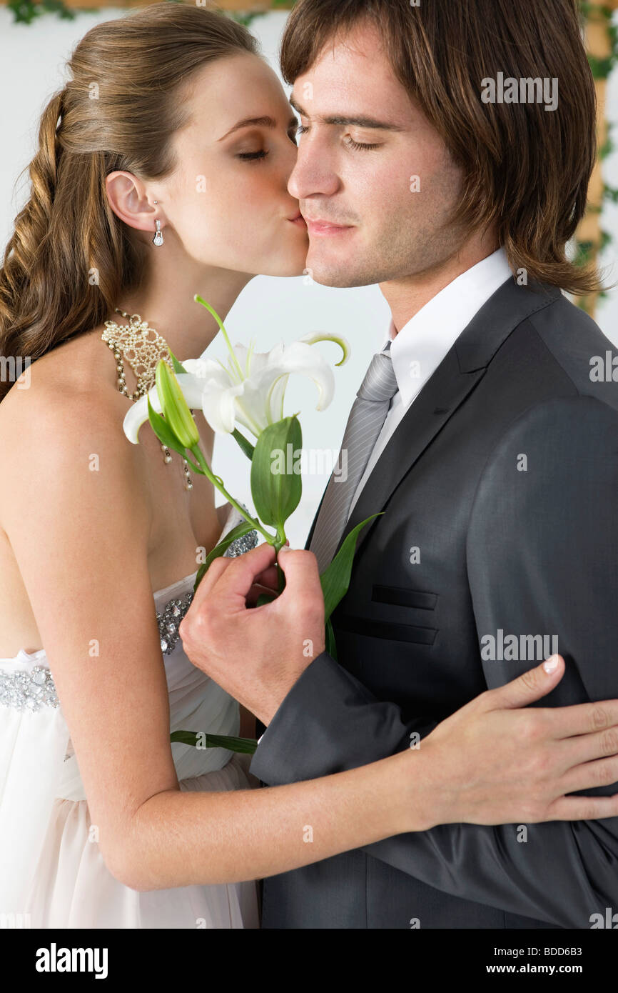Bride kissing groom Stock Photo - Alamy