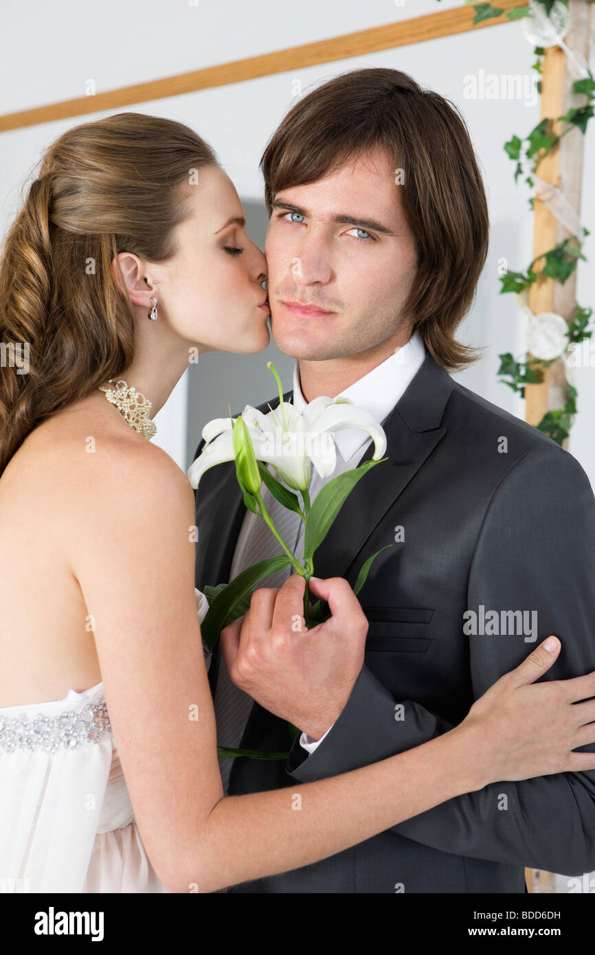 Bride kissing groom Stock Photo - Alamy