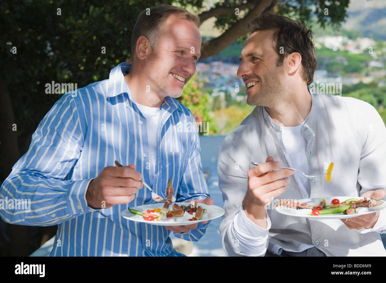 Two friends eating fruit salad Stock Photo - Alamy