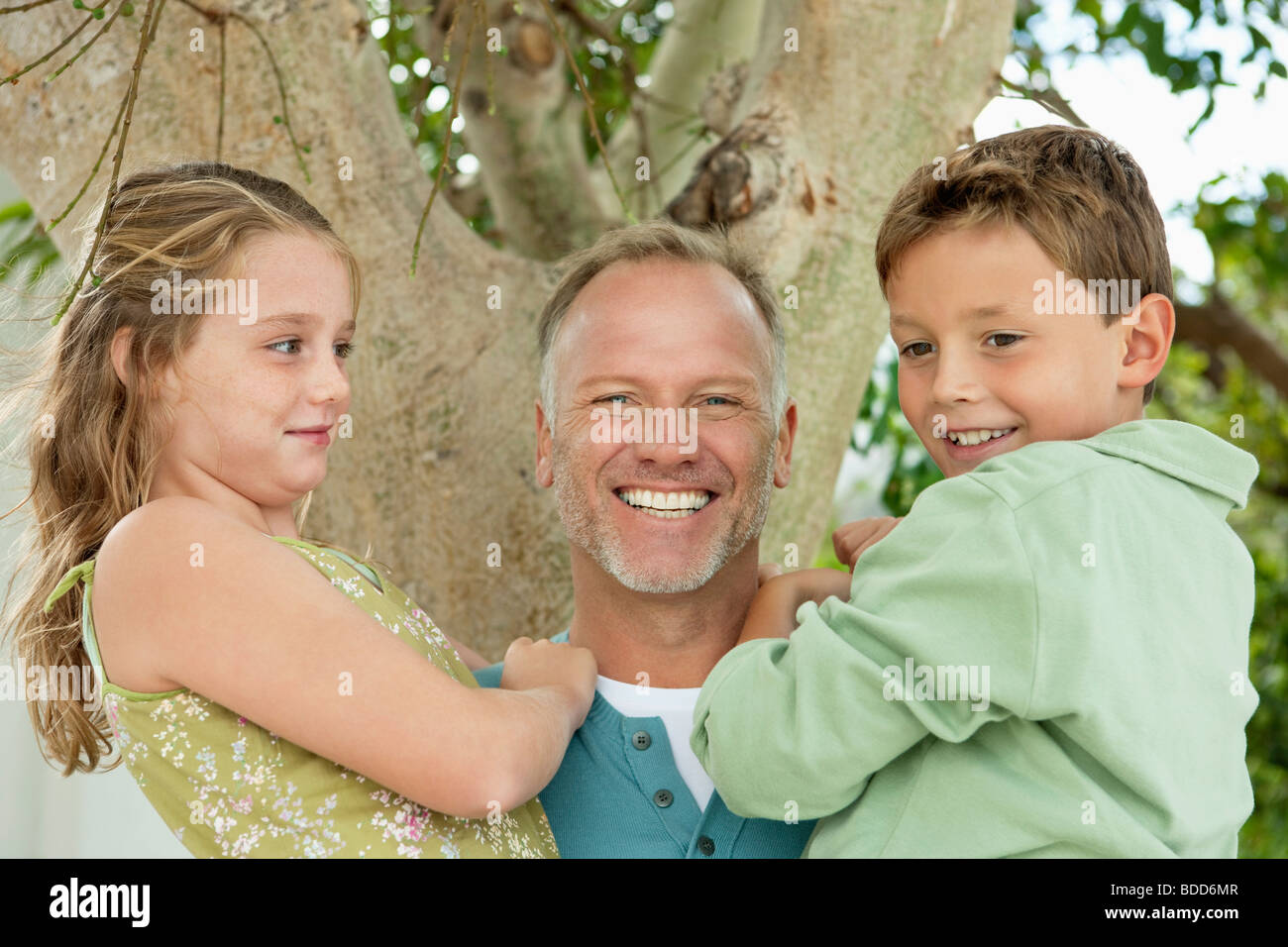 Man carrying his children Stock Photo - Alamy