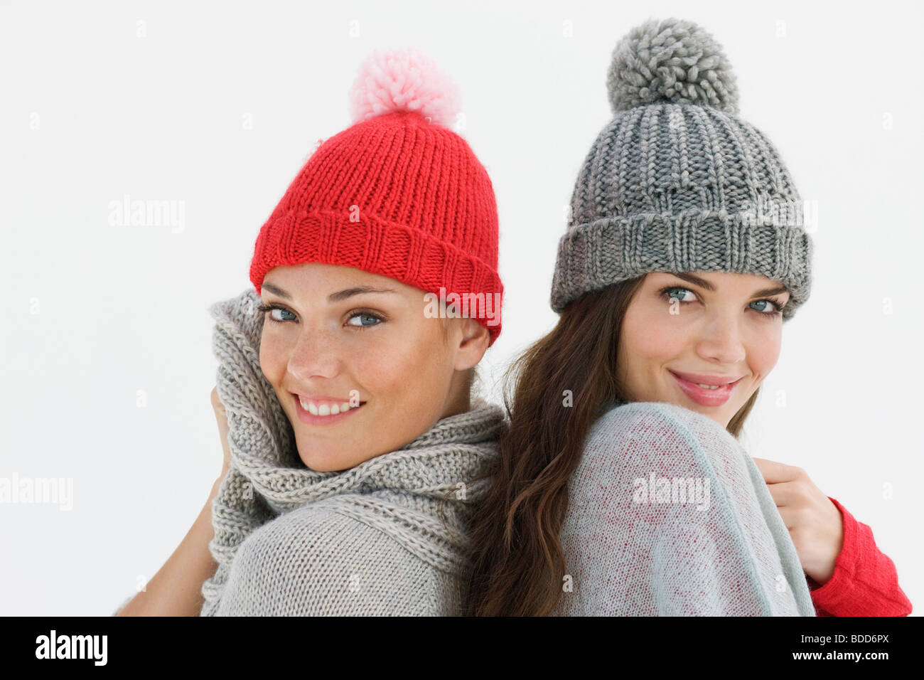 Portrait of two women smiling back to back Stock Photo - Alamy