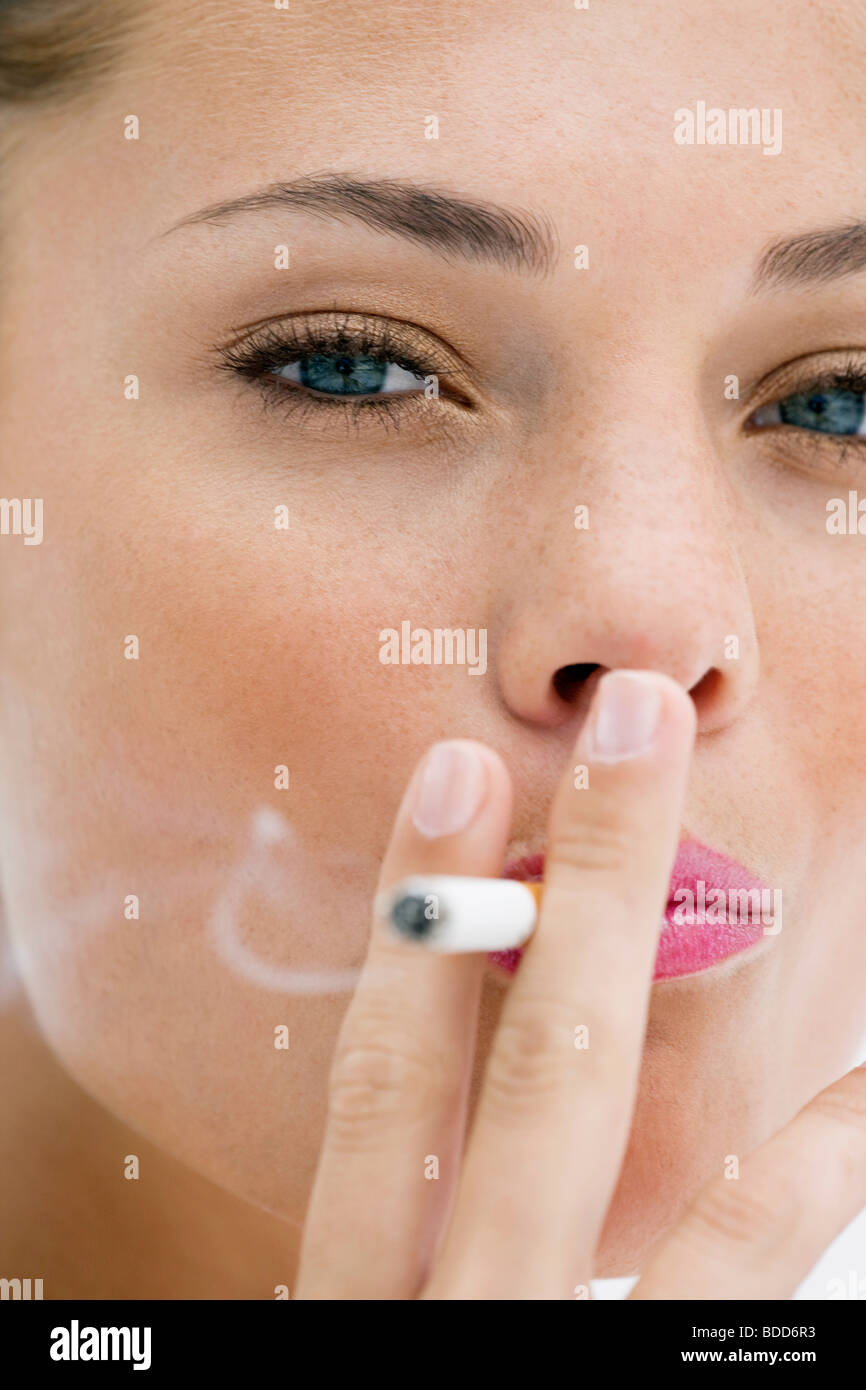 Portrait of a woman smoking a cigarette Stock Photo - Alamy
