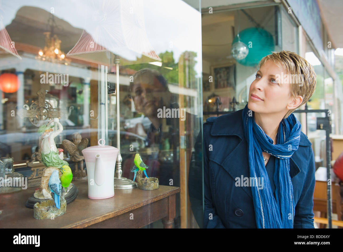Woman window shopping in a store Stock Photo - Alamy