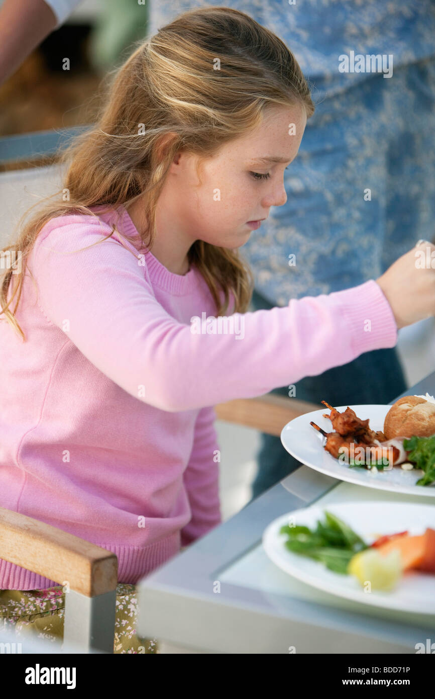 Girl having breakfast at a dining table Stock Photo - Alamy