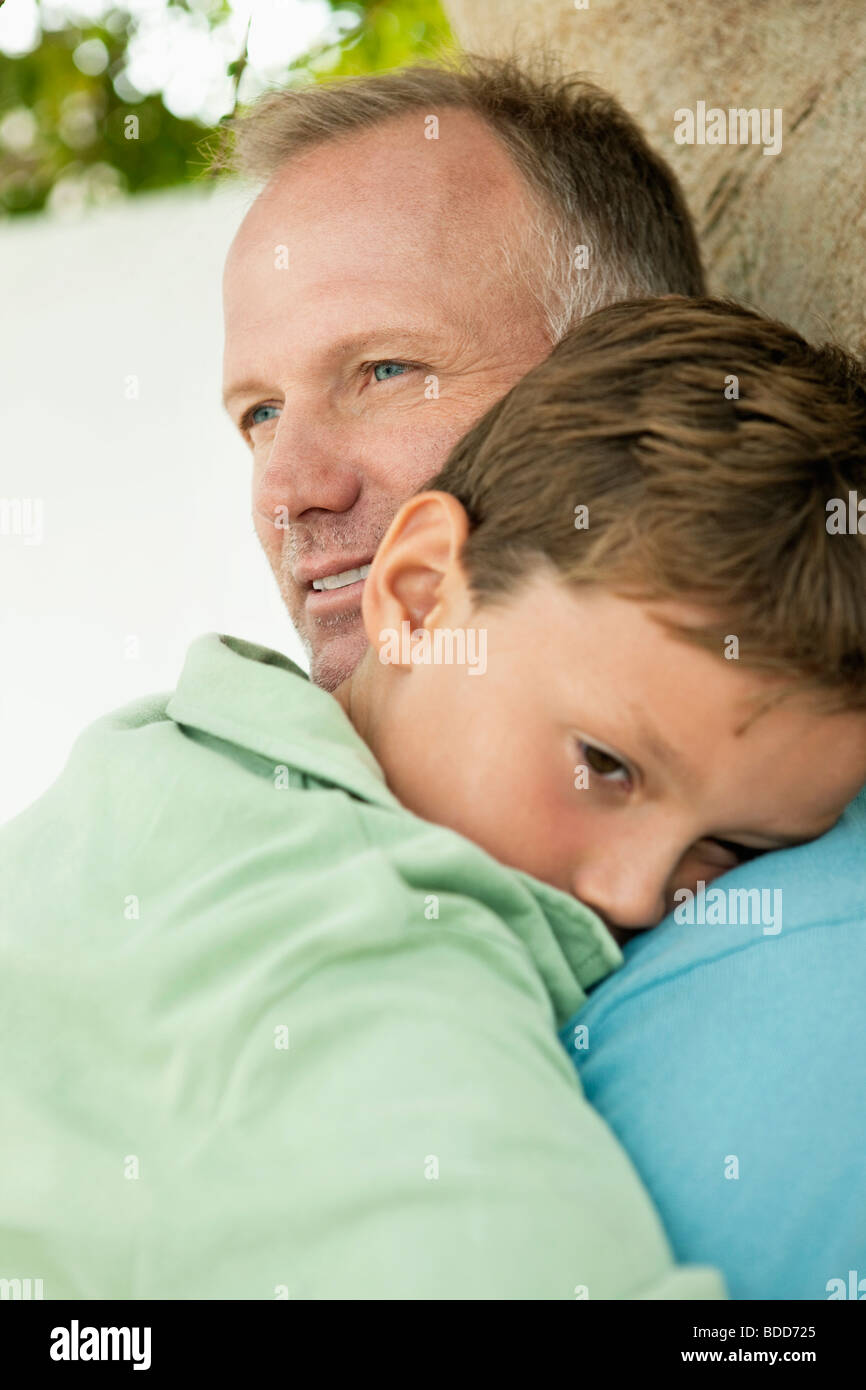 Boy hugging his father Stock Photo - Alamy