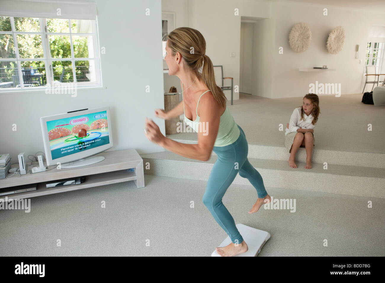 Woman doing step aerobics and watching TV Stock Photo - Alamy