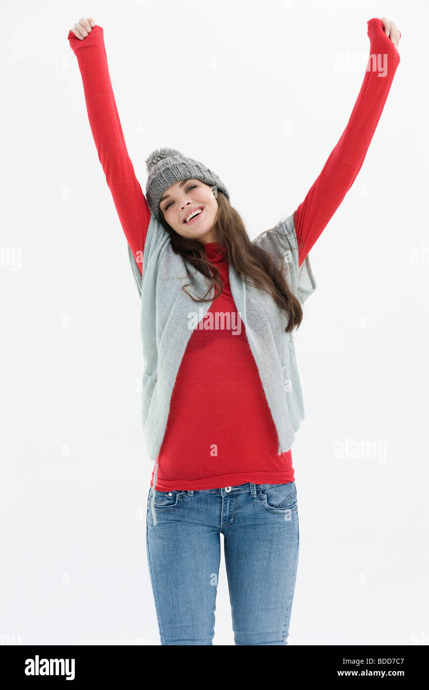 Woman standing with her arms raised and smiling Stock Photo - Alamy