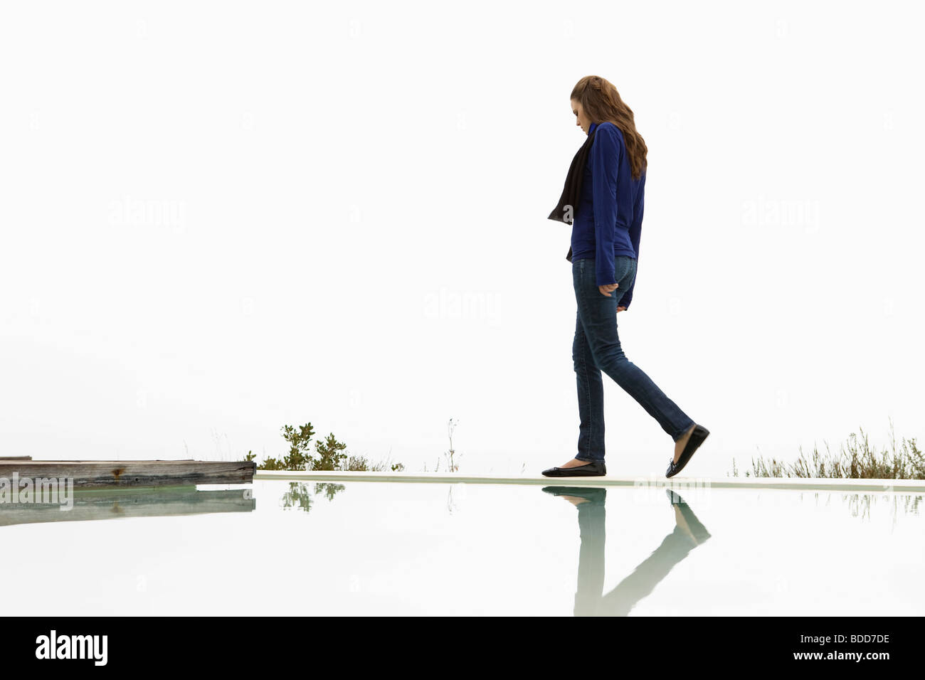 Woman walking at the poolside Stock Photo - Alamy