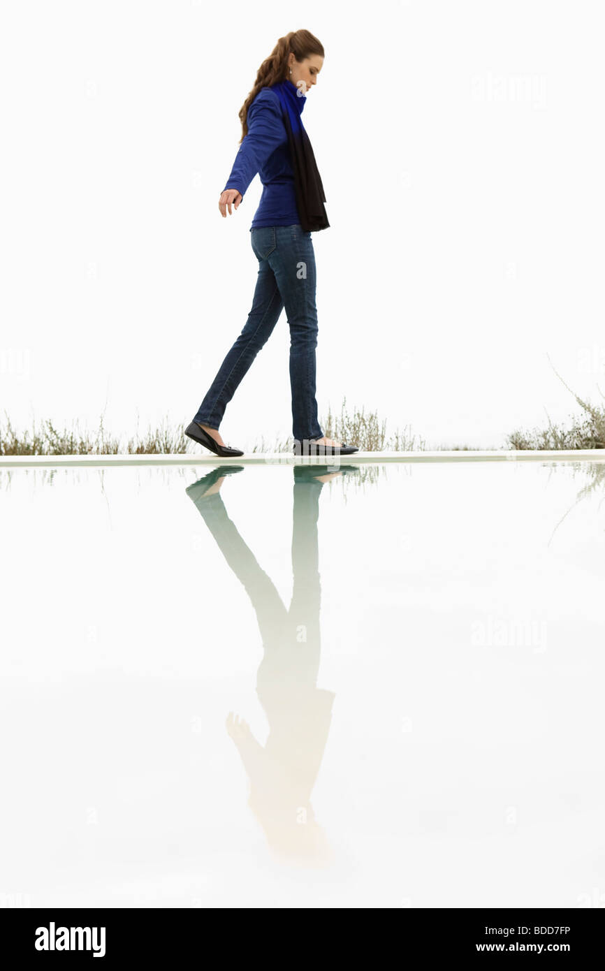 Woman walking at the poolside Stock Photo - Alamy