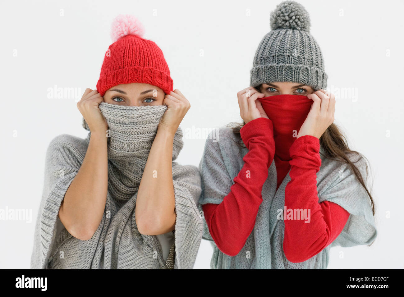 Portrait of two women hiding their faces Stock Photo - Alamy