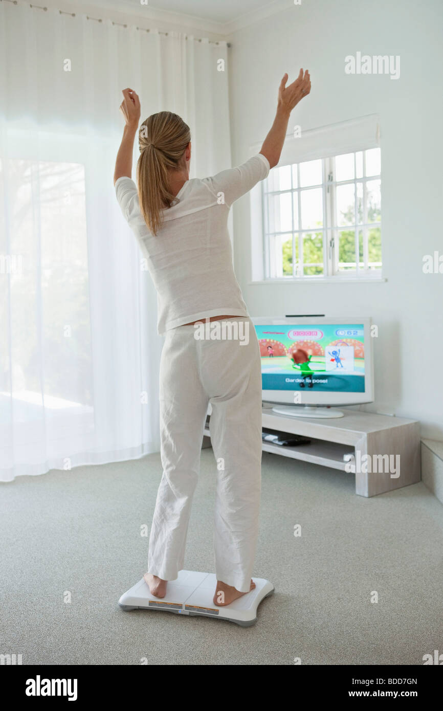 Woman doing step aerobics and watching TV Stock Photo - Alamy