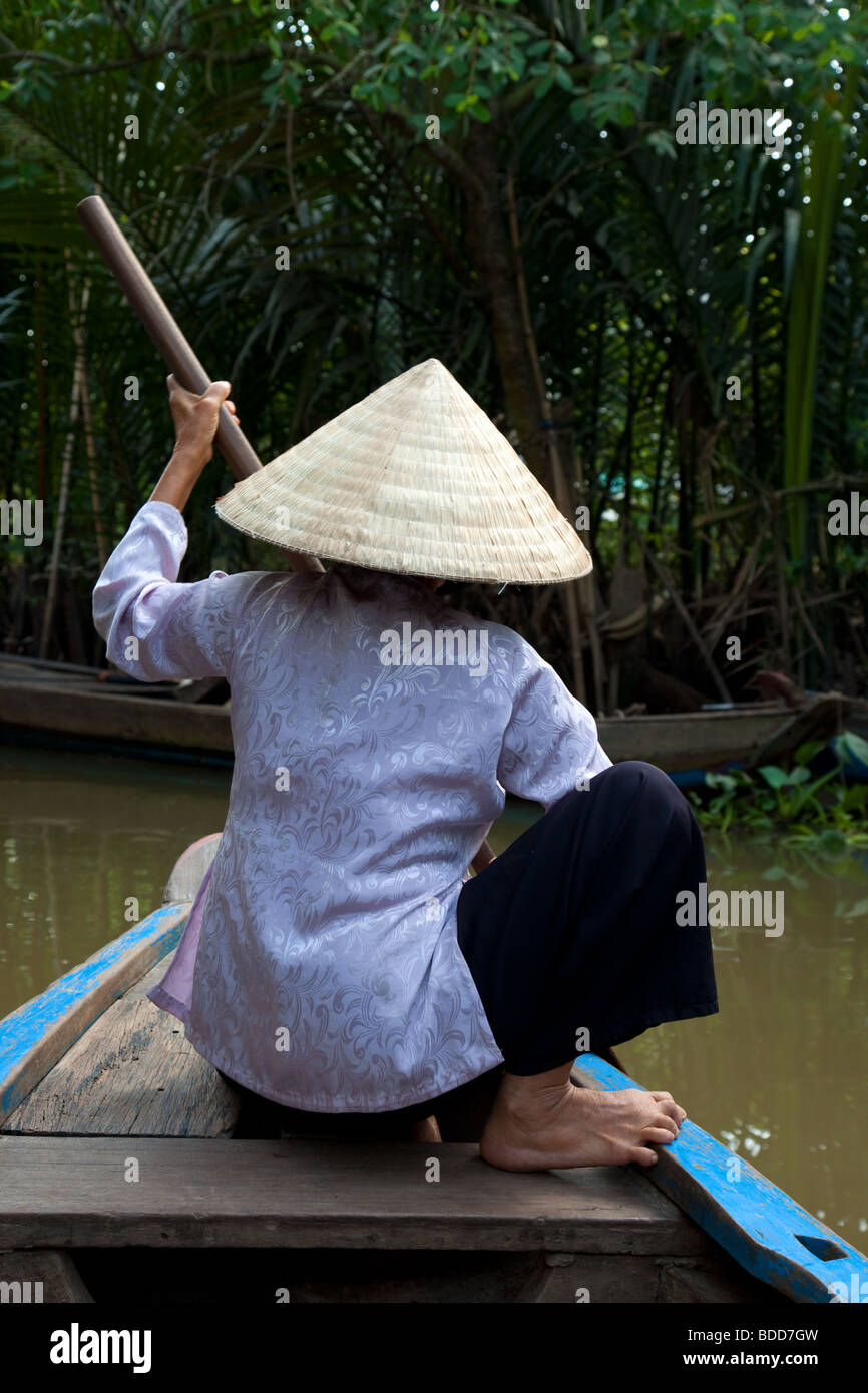 Vietnamese woman steers a sampan through the Mekong Delta Stock Photo ...