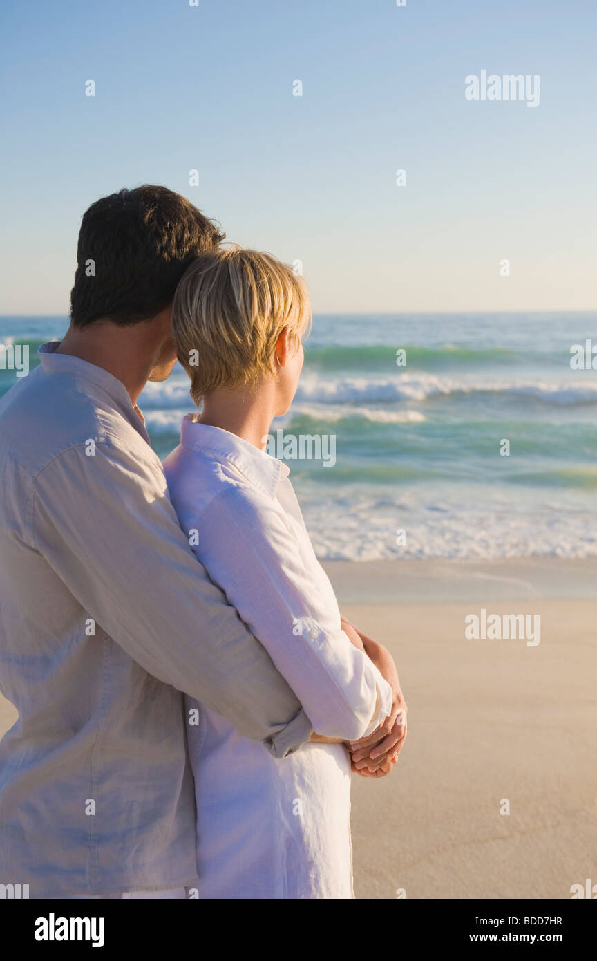 Man embracing a woman from behind Stock Photo - Alamy