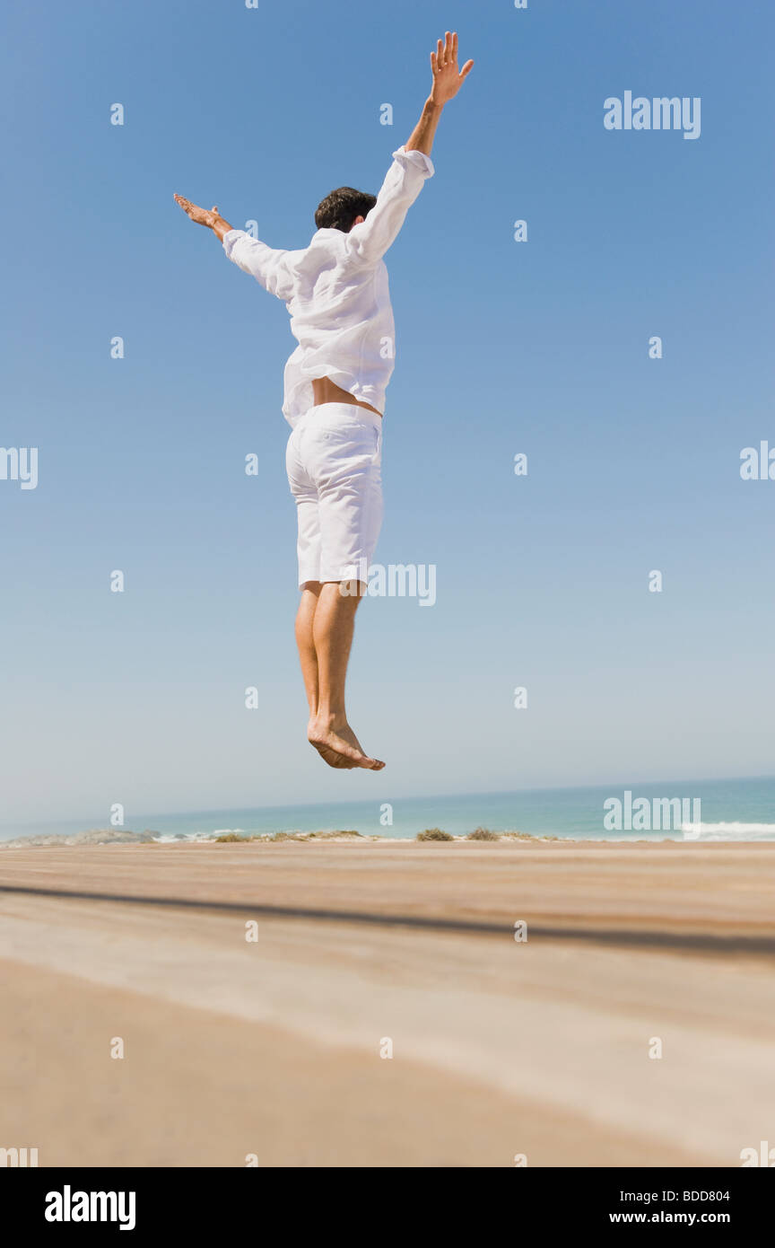 Man jumping on the beach Stock Photo - Alamy