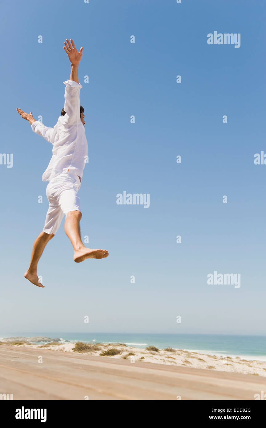 Man jumping on the beach Stock Photo - Alamy