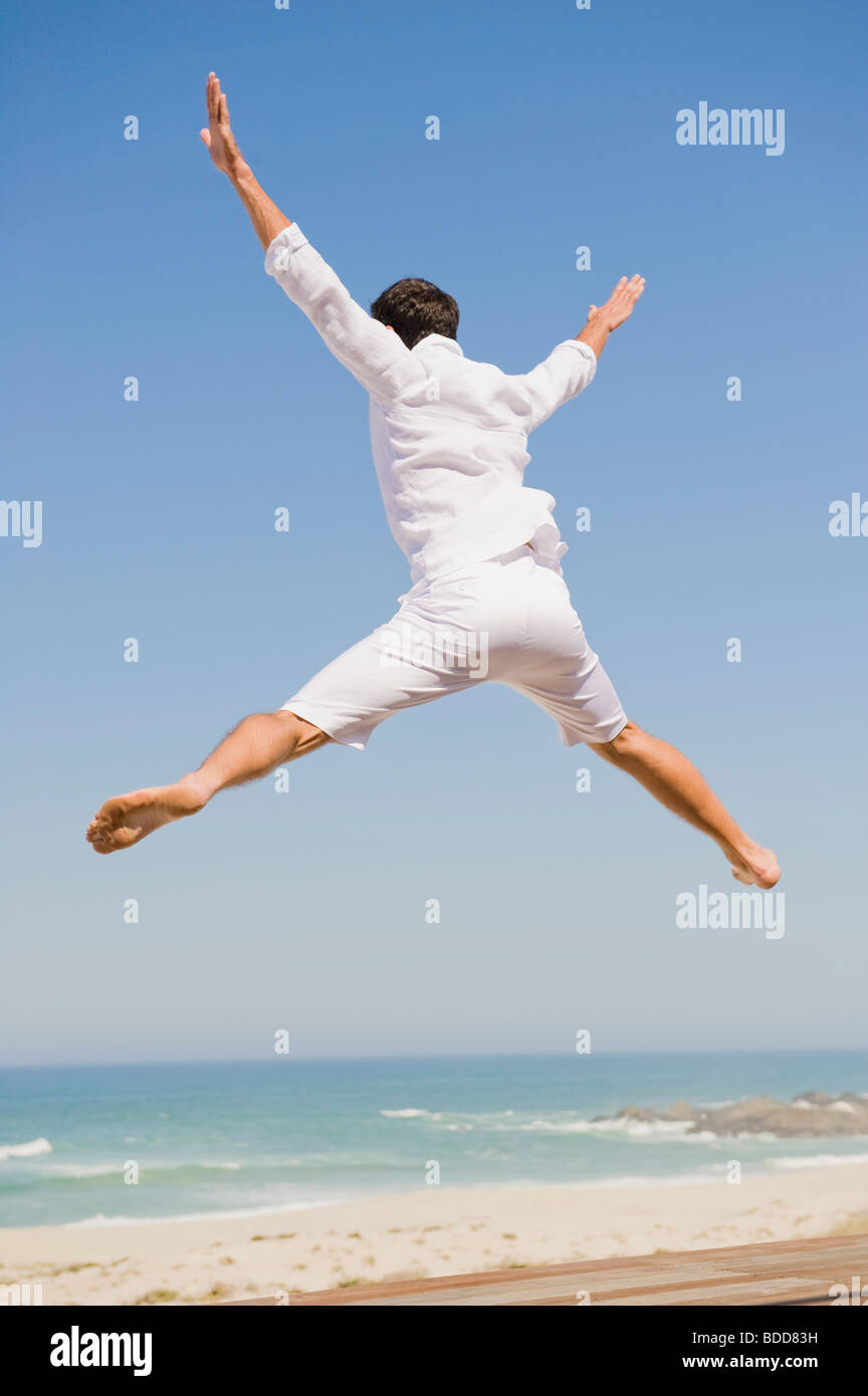 Man jumping on the beach Stock Photo - Alamy
