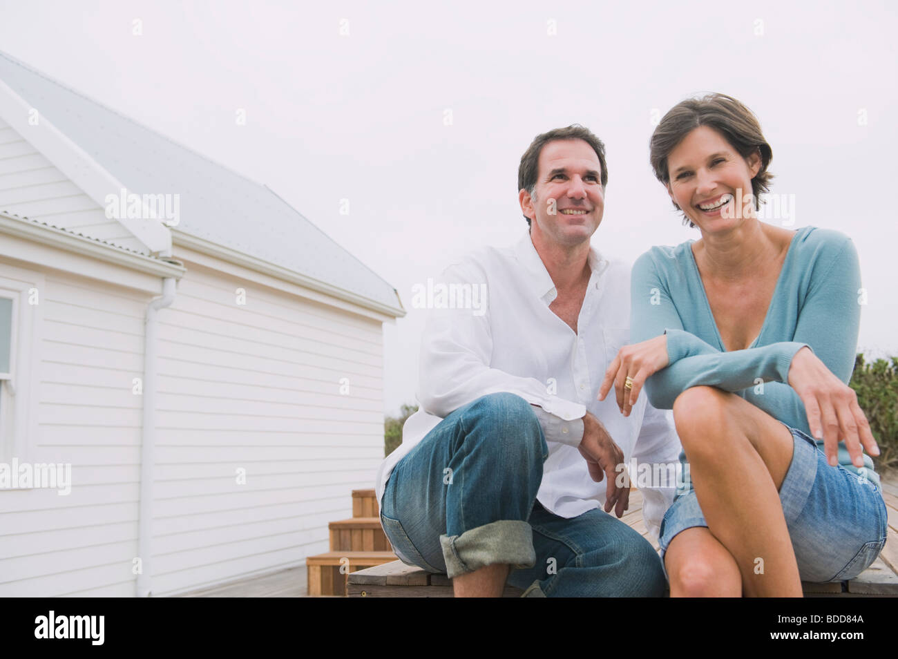 Couple sitting together and smiling Stock Photo - Alamy