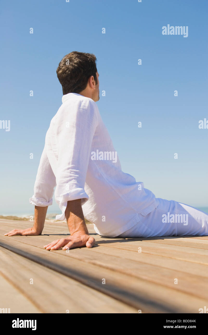 Man sitting on the beach Stock Photo - Alamy
